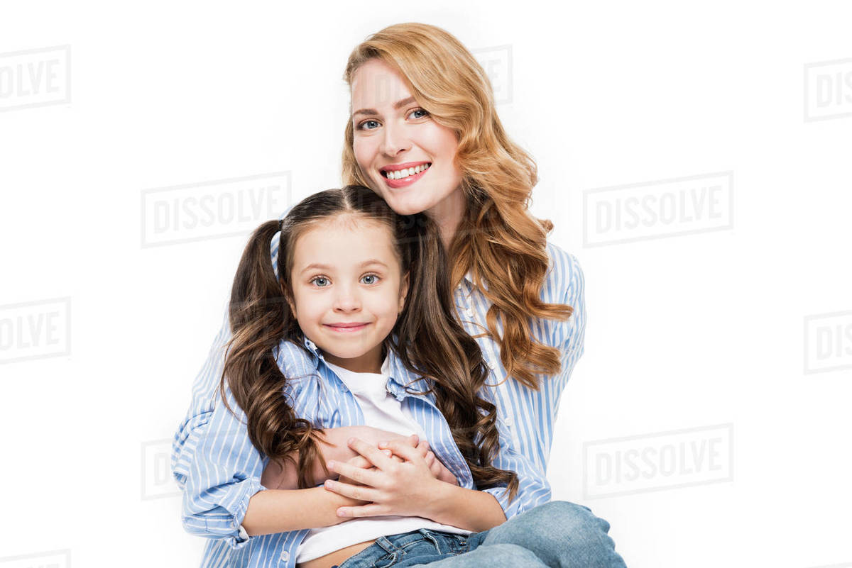 portrait of smiling mother hugging little daughter isolated on white - Stock Photo - Dissolve