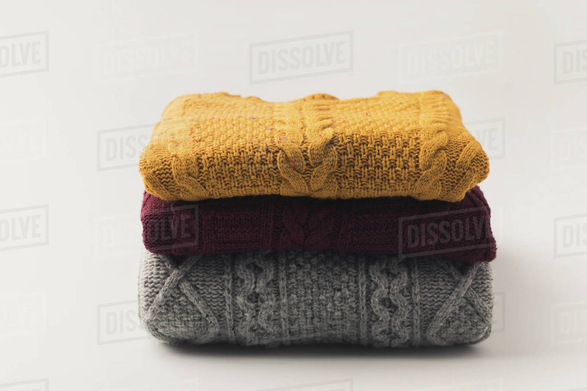 Pile of warm cozy sweaters, isolated on white - Royalty-free Stock ...