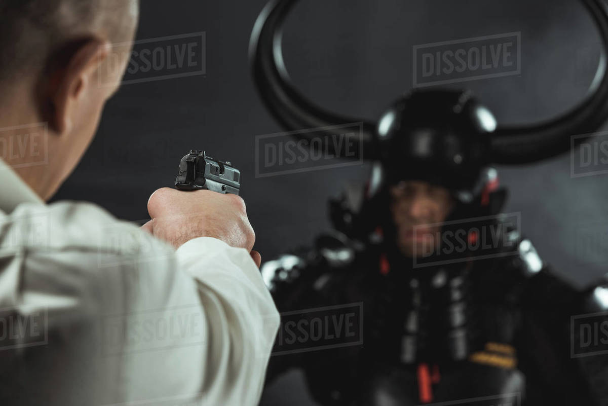 Close-up shot of man aiming on armored samurai with gun - Royalty-free ...