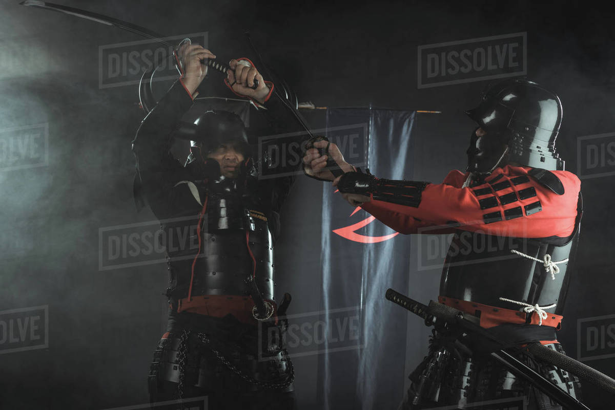 Armored samurai fighting with swords in front of clan symbols on flags ...