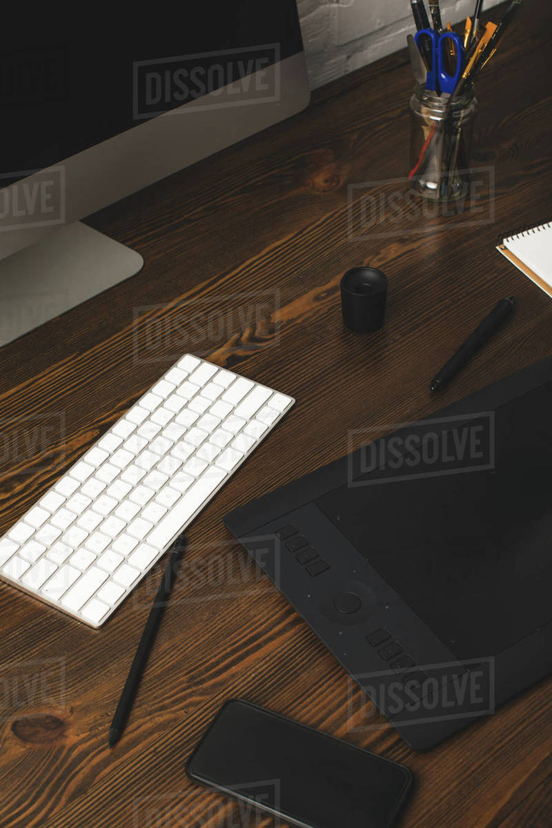Close-up view of desktop computer, graphics tablet and keyboard on ...