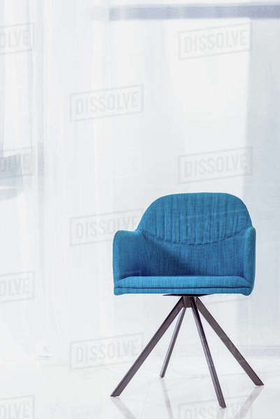 Blue modern chair in room in front of window - Stock Photo - Dissolve