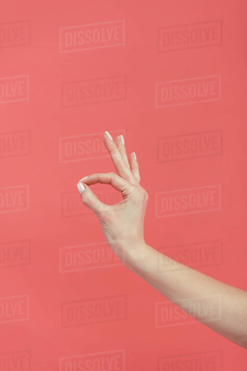 Cropped view of female hand with ok sign, isolated on red - Royalty ...