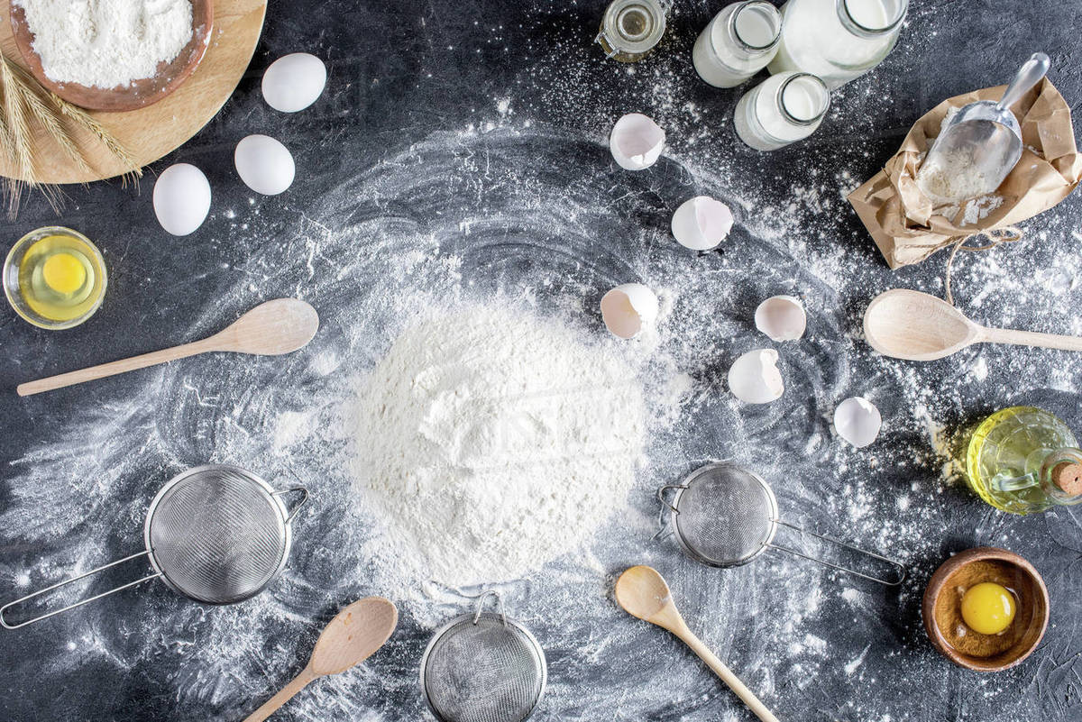 Flat lay with flour and other ingredients for bakery, wooden ...
