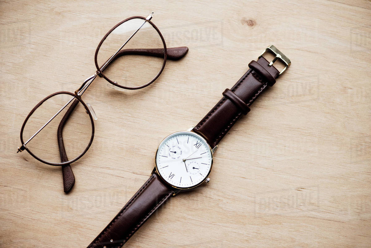 Top view of glasses and watch on wooden surface - Royalty-free Stock ...