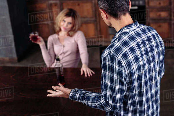 Selective focus of man and drunk wife with alcohol at home - Royalty ...