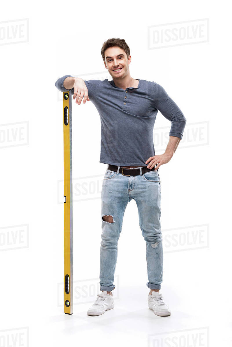 Handsome man holding building level isolated on white, handyman tools ...