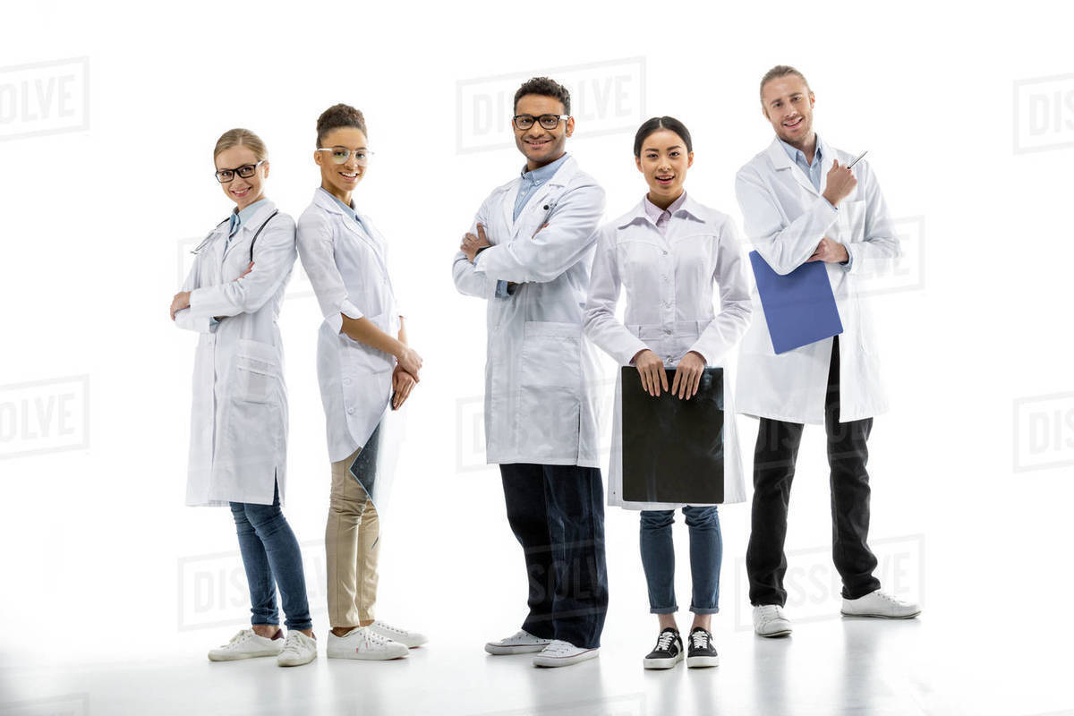 Team of young professional doctors standing together isolated on white ...