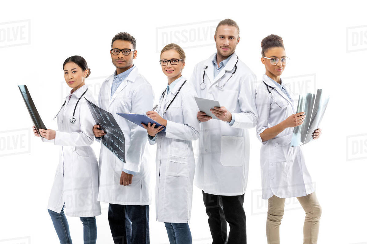 Group of young smiling professional doctors standing together isolated ...