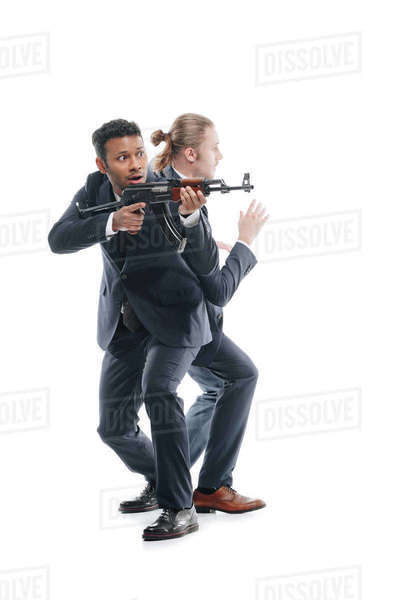 African american bodyguard with rifle and frightened client, isolated ...
