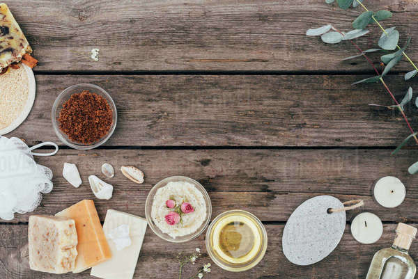 Top view of natural soap, spa treatment and salt scrub on wooden table ...