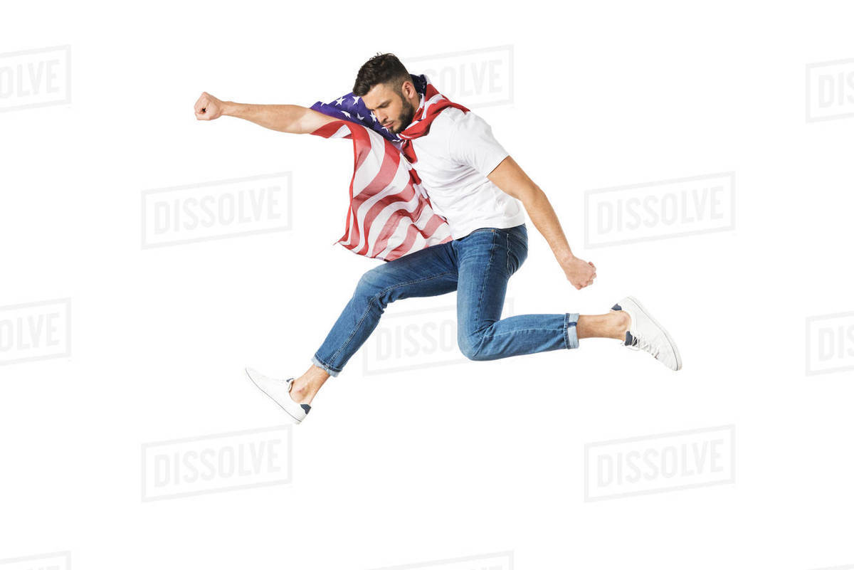 Handsome young man with american flag flying with raised hand isolated ...