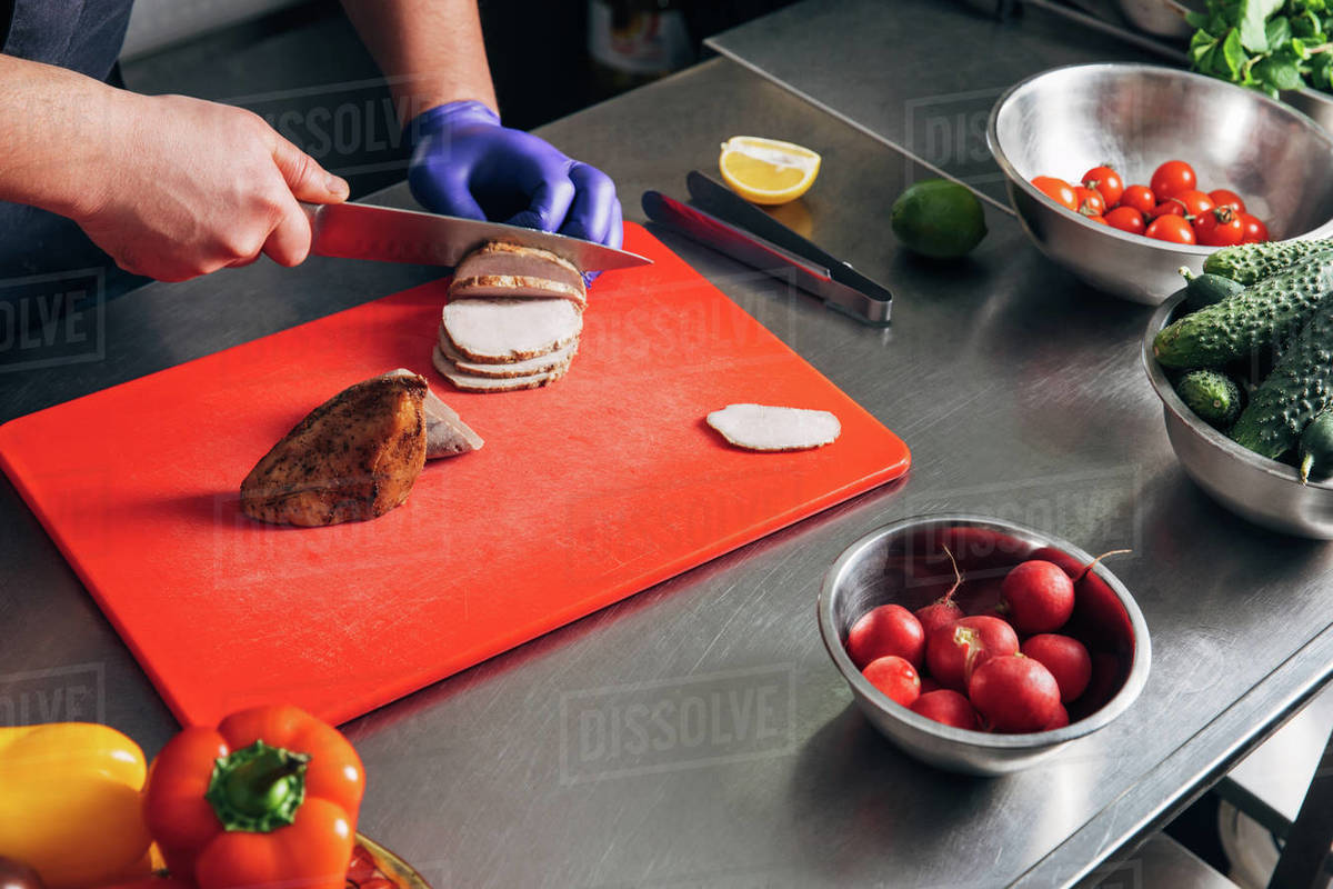 Cropped shot of chef slicing meat at kitchen - Royalty-free Stock Photo ...