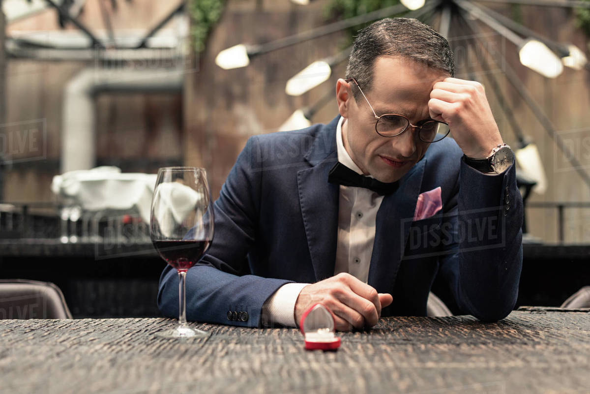 depressed man in suit with proposal ring crying after he get refused ...