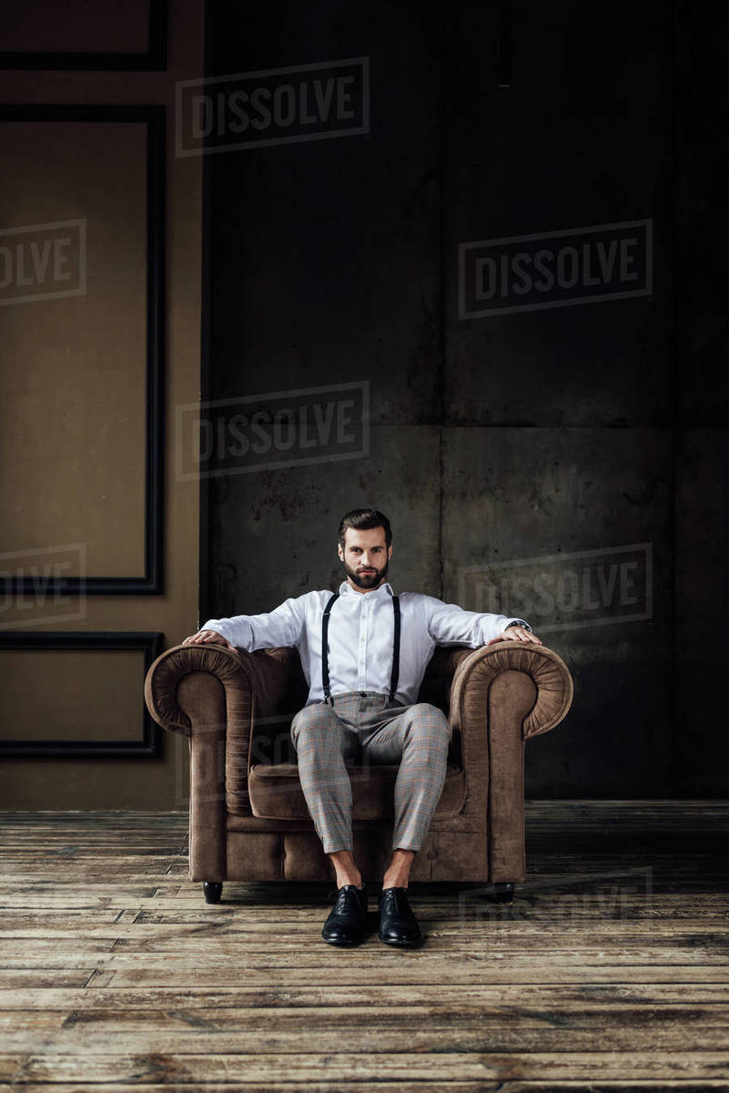 Handsome stylish man thinking and sitting in armchair - Royalty-free ...