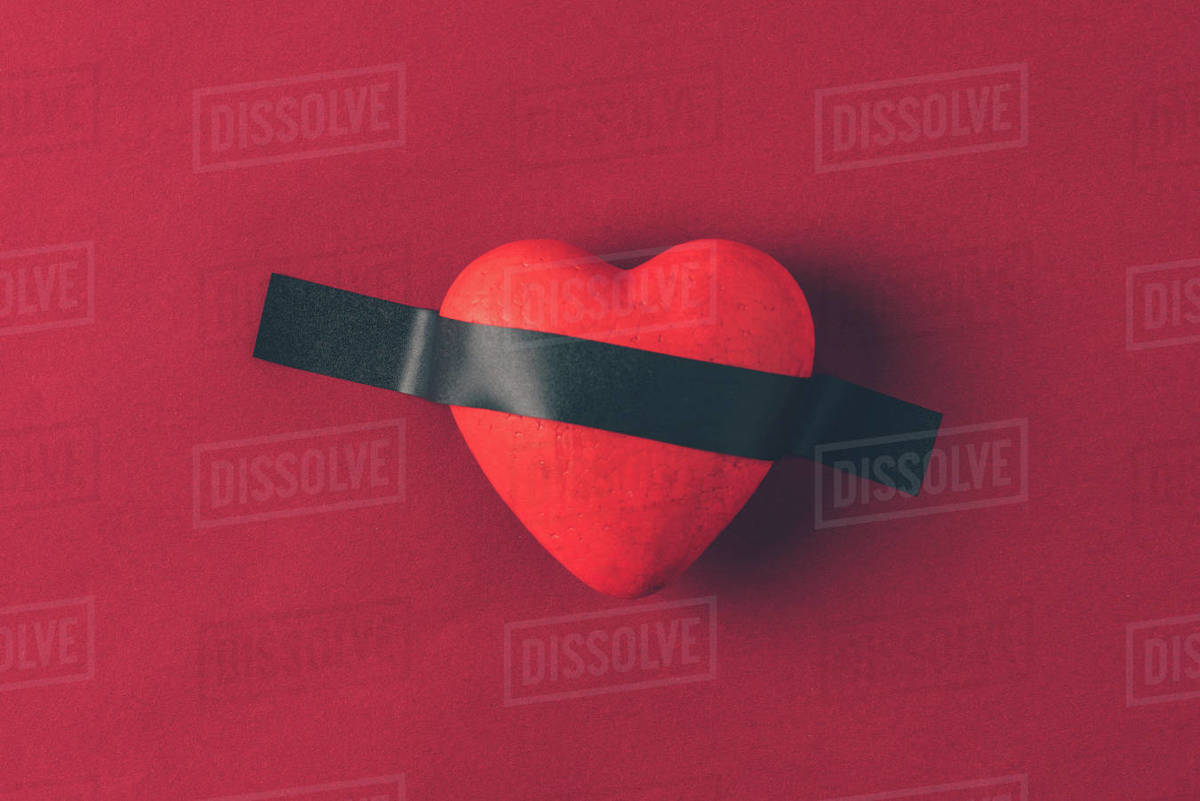 Top view of red heart under insulating tape on red - Royalty-free Stock ...