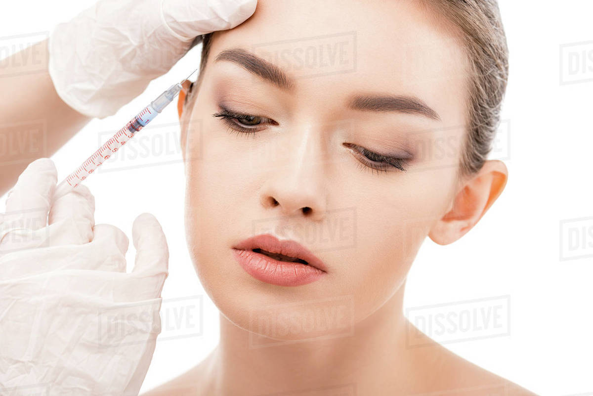 Attractive girl doing beauty injection, isolated on white - Royalty ...