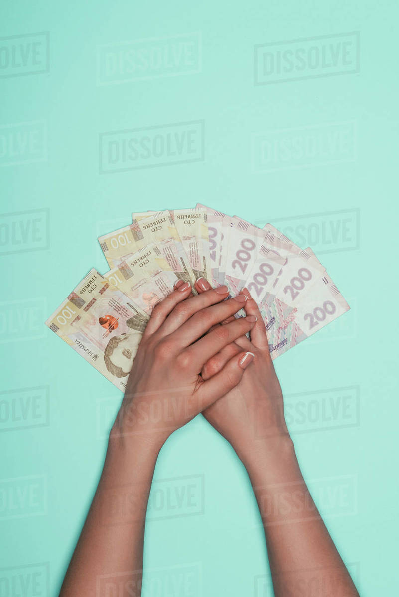 Cropped shot of woman with bunch of cash isolated on turquoise - Stock ...