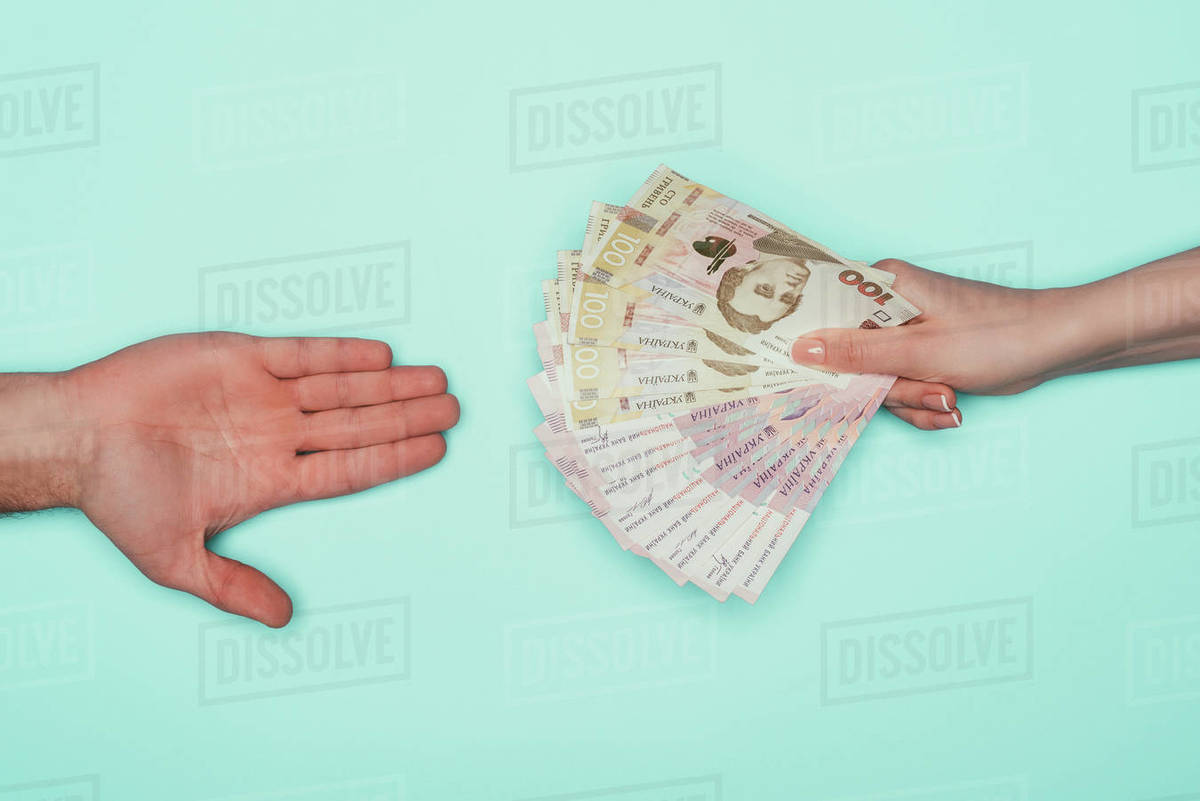 Cropped shot of people passing cash isolated on turquoise - Royalty ...
