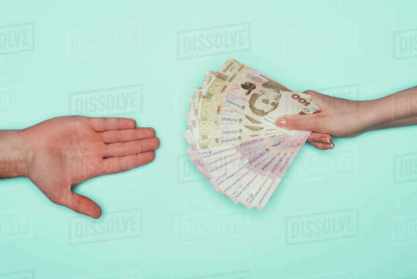 Cropped shot of people passing cash isolated on turquoise - Royalty ...