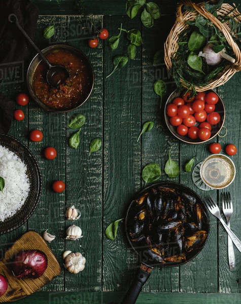 Top view of cooked mussels with shells served in pan with tomatoes ...