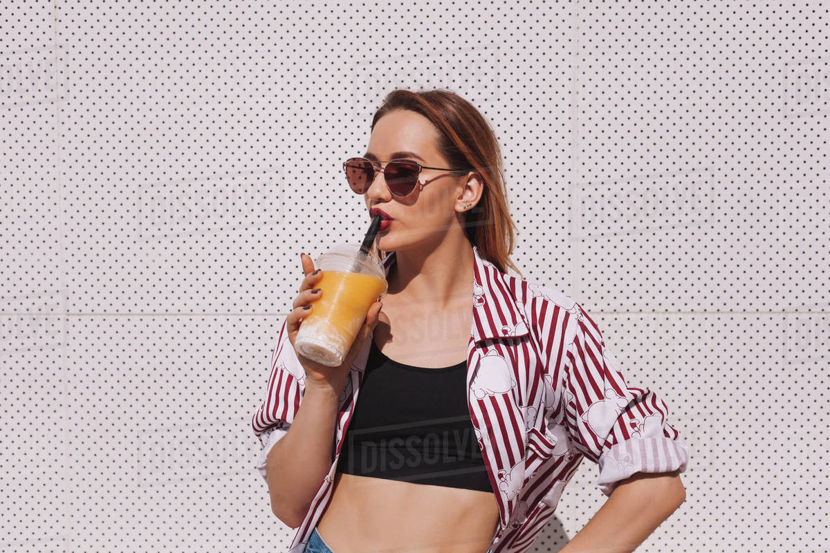 Beautiful young woman with mango shake in plastic cup - Royalty-free ...