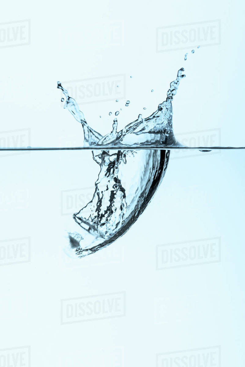 Ice cube in water with splash, isolated on white - Royalty-free Stock ...