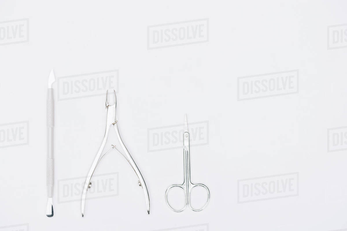 Top view of nail nippers and scissors isolated on white - Royalty-free ...