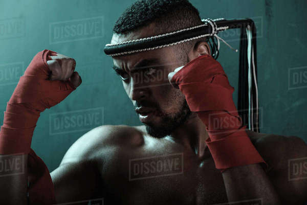 Close-up portrait of aggressive young muay thai boxer training thai ...