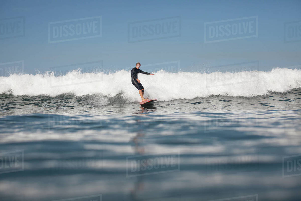 Active surfer having fun and riding wave on board in ocean - Royalty ...