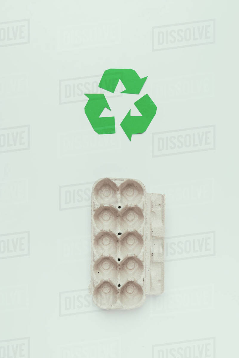 Top view of recycle sign and empty carton egg box isolated on grey ...
