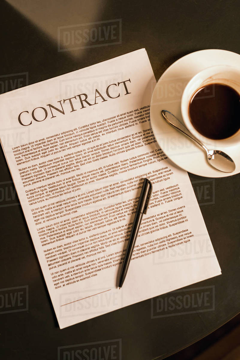top view of contract and cup of coffee on dark tabletop - Royalty-free ...