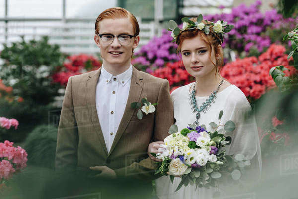 beautiful elegant young redhead wedding couple smiling at camera ...