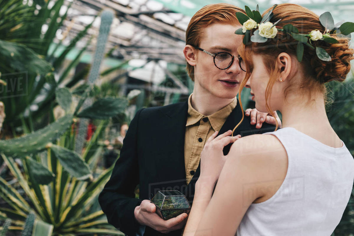 beautiful young red-haired wedding couple with engagement ring in ...