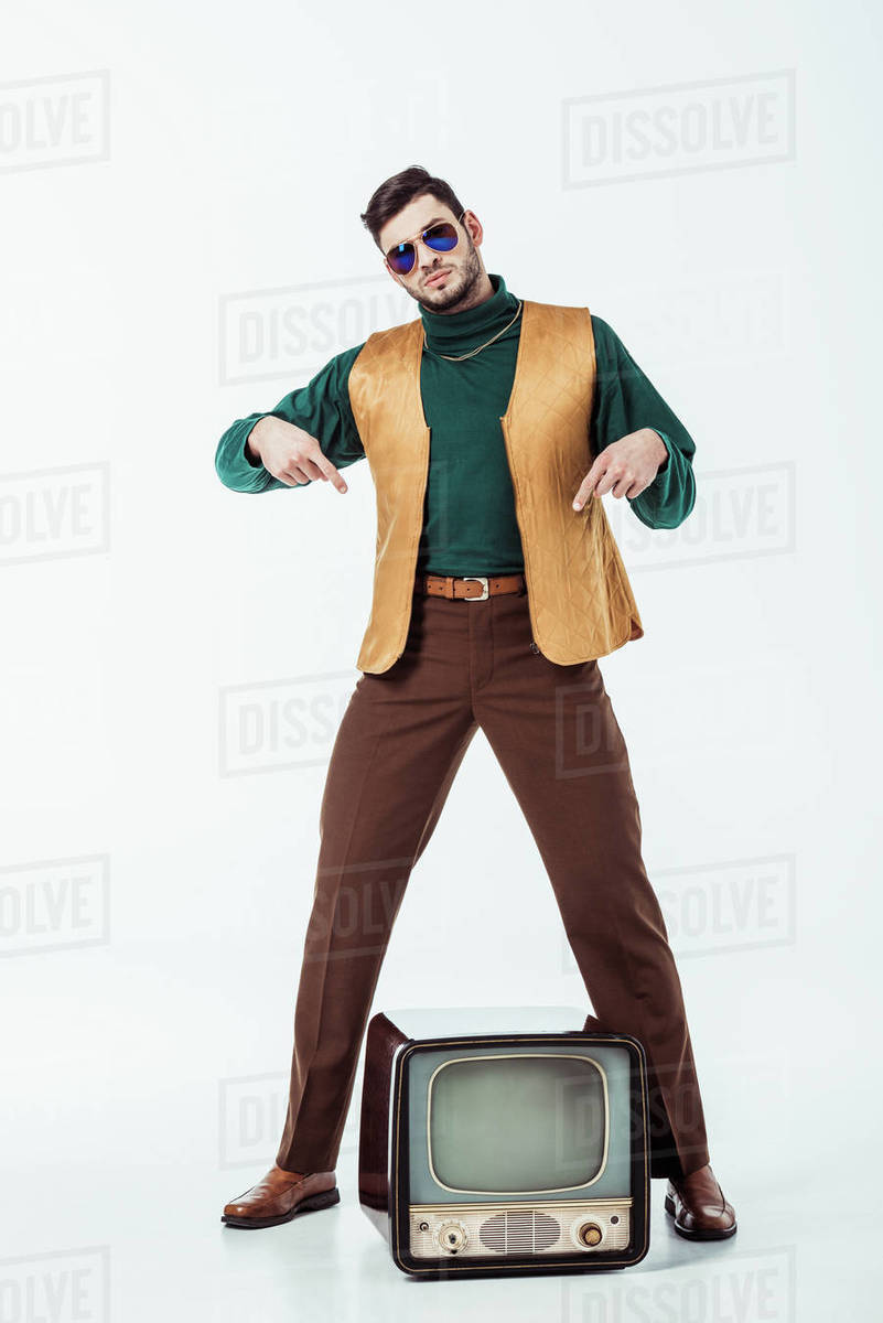 Handsome retro styled man pointing on television on white - Royalty ...