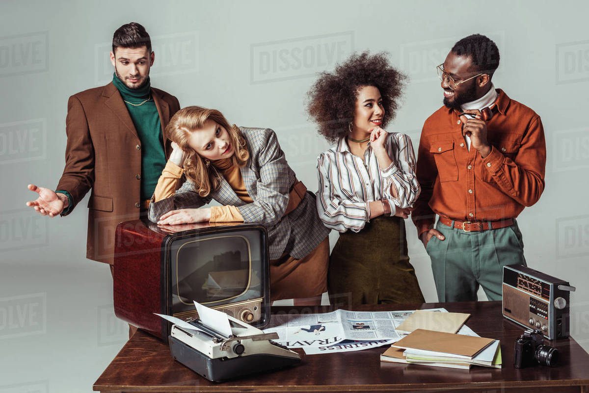 Happy multicultural retro styled journalists at newsroom isolated on ...