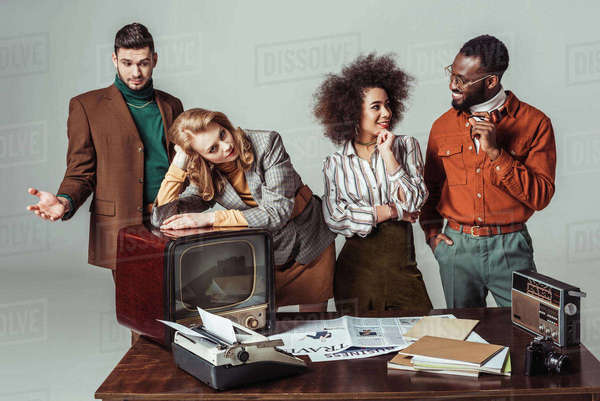 Happy multicultural retro styled journalists at newsroom isolated on ...
