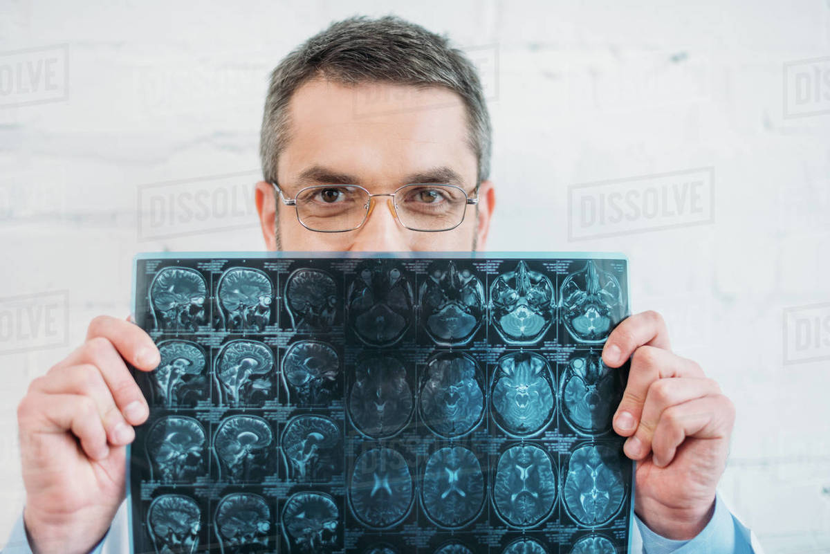 Doctor covering half of face with mri scan - Royalty-free Stock Photo ...