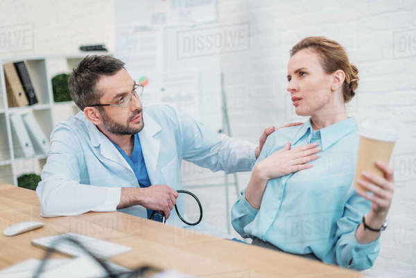 Doctor giving consultation for female patient at workplace in office ...