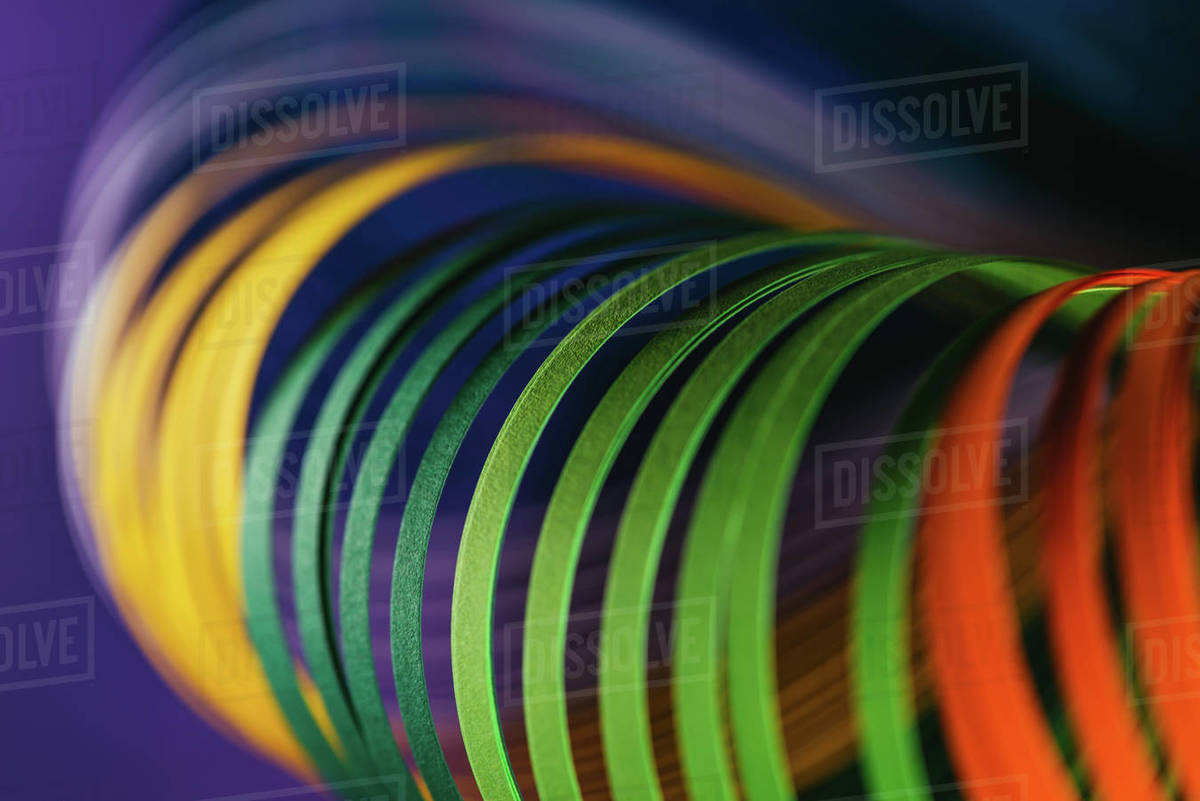Close up of colored quilling paper curves on purple - Stock Photo ...