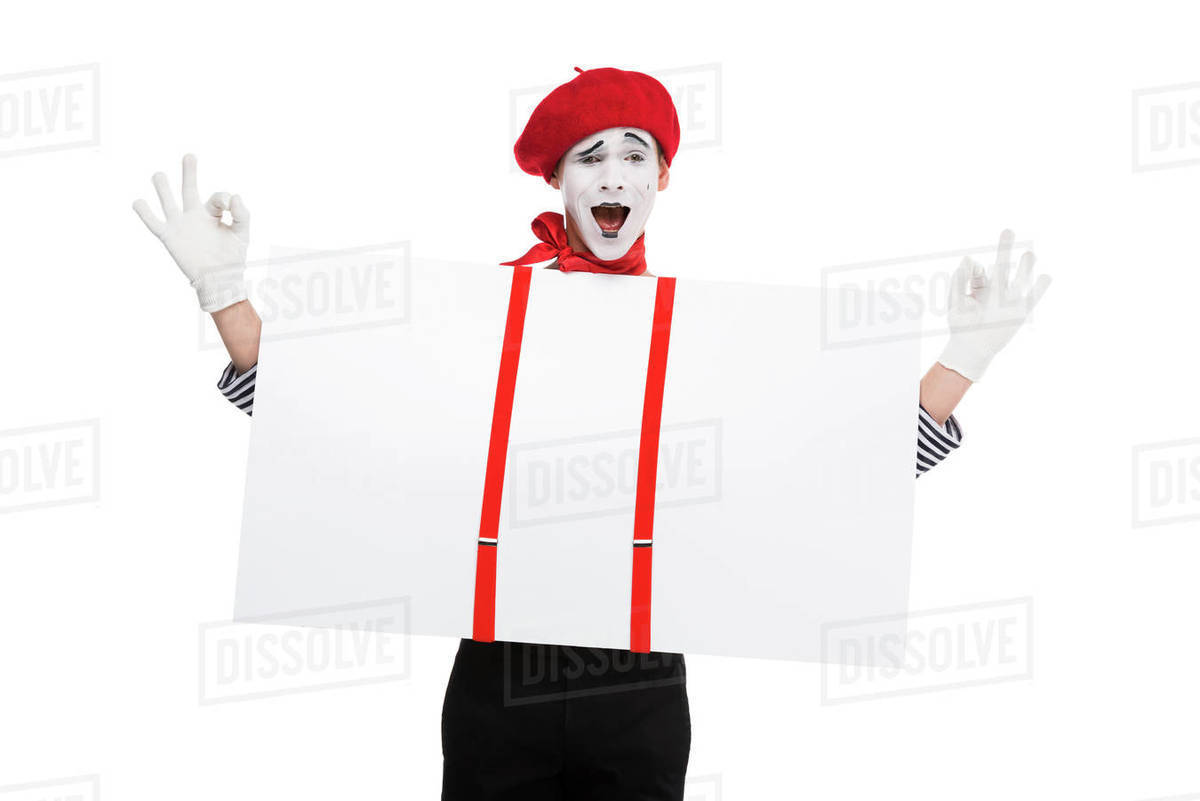 Happy mime holding empty board under suspenders and showing ok sign ...