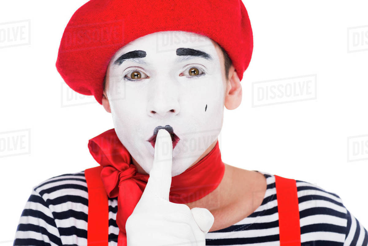 Portrait of mime showing silence gesture isolated on white - Royalty ...