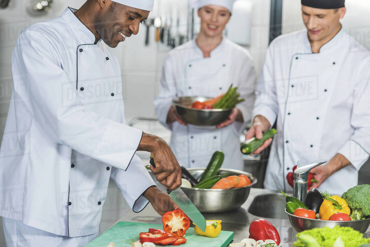 Multicultural chefs cooking salad at restaurant kitchen - Stock Photo ...