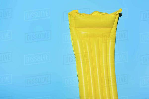 Yellow inflatable mattress on blue with copy space - Royalty-free Stock ...