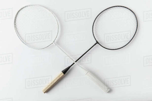 top view of crossed badminton rackets on white surface - Stock Photo ...