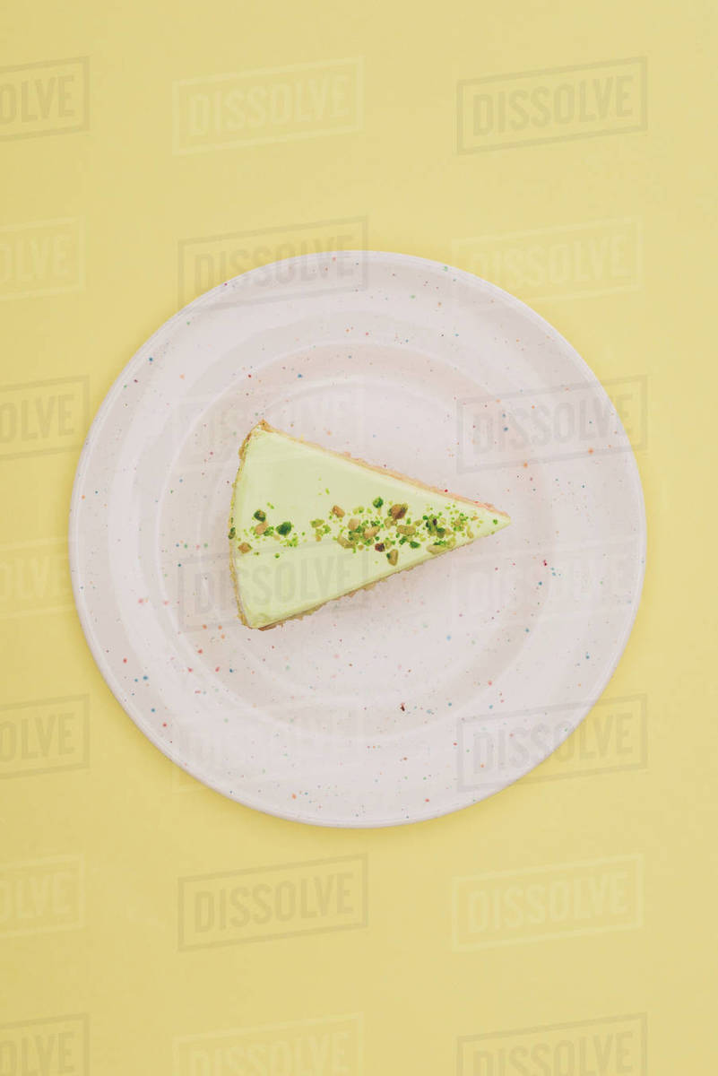 top view of piece of cake on plate isolated on yellow - Royalty-free ...
