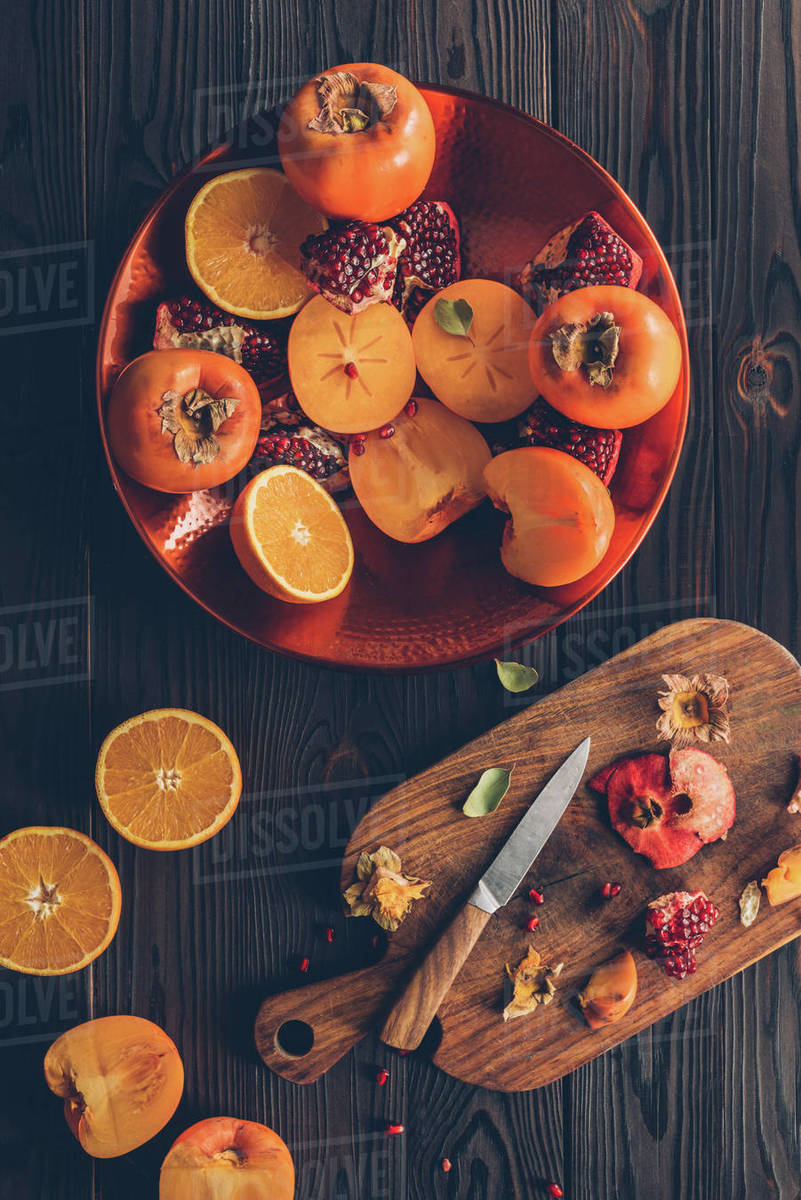 top view of cut fruits and wooden board on table - Royalty-free Stock ...