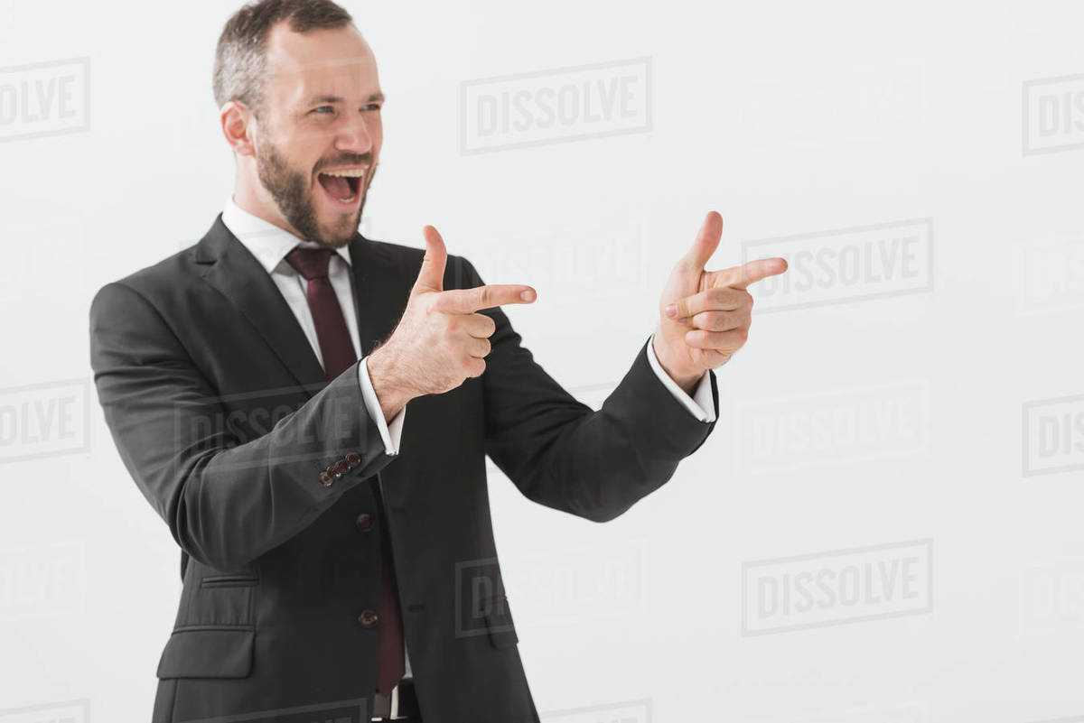 portrait of excited young businessman pointing away isolated on white ...