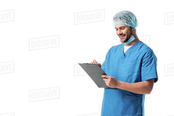 Cheerful surgeon wearing blue uniform and holding clipboard isolated on ...