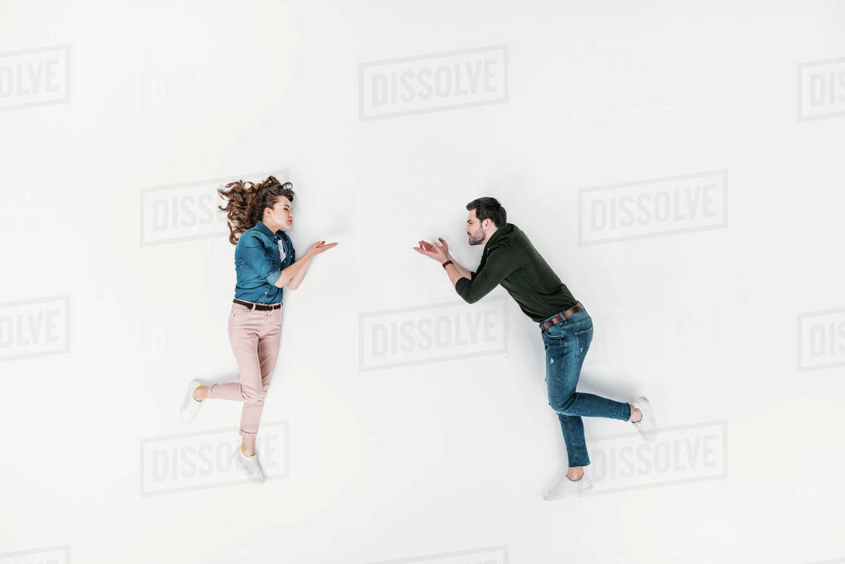 Top view of woman throwing blown kiss to boyfriend isolated on white ...